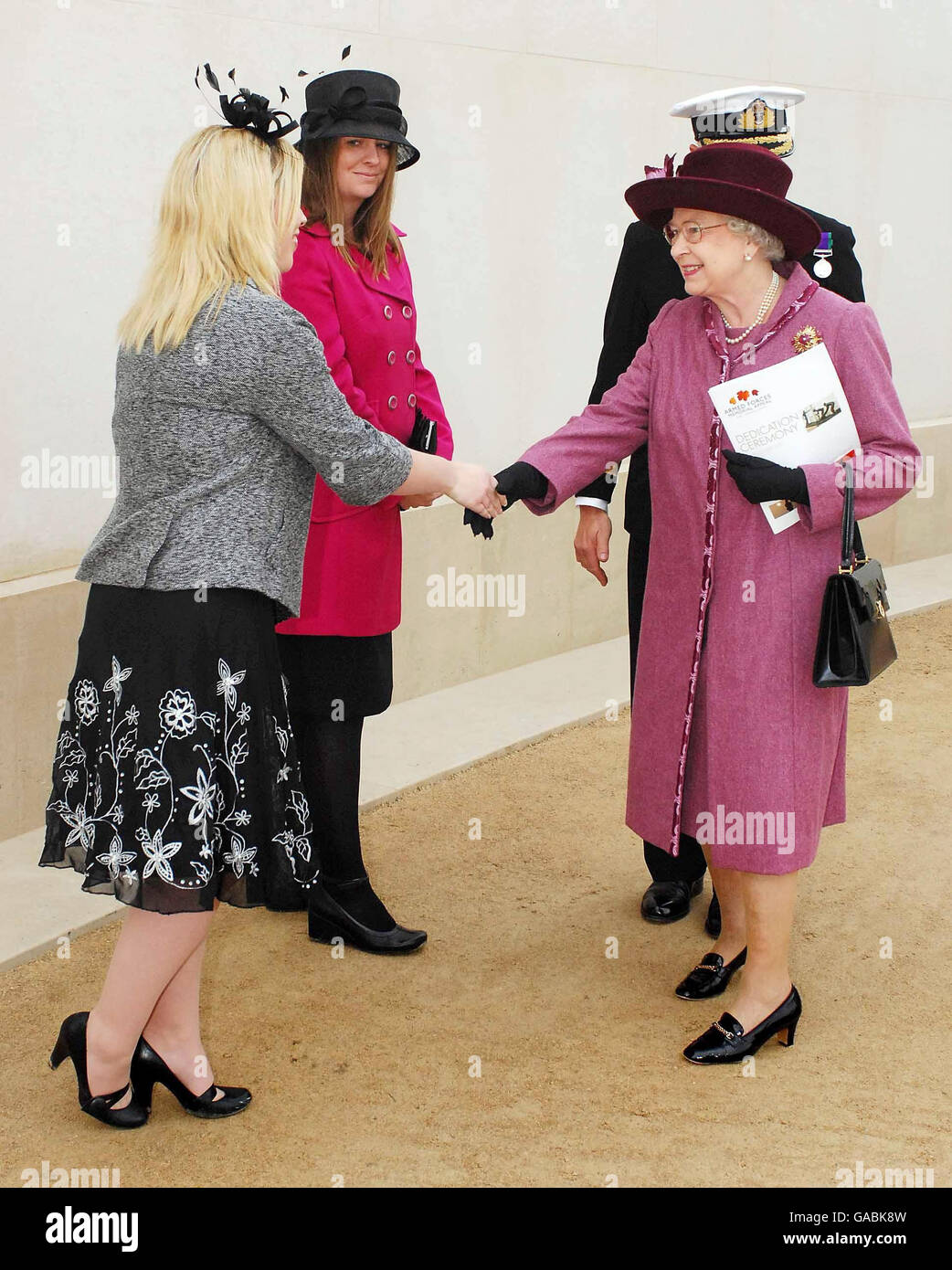 Britain's Queen Elizabeth II meets Tracy Wilson, whose husband Danny ...