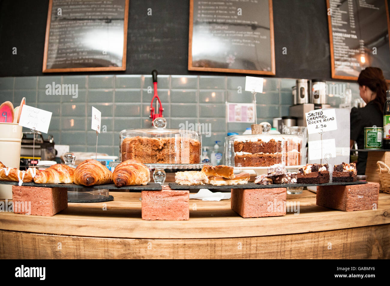 Freshly baked cakes and croissant inside a cafe Stock Photo - Alamy