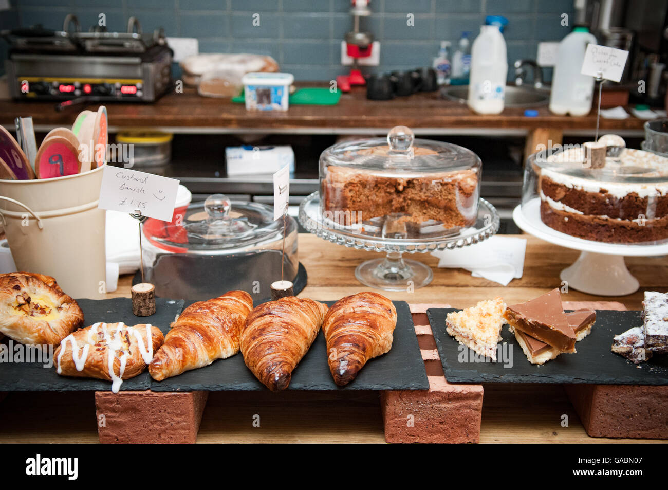 Freshly baked cakes and croissant inside a cafe Stock Photo - Alamy
