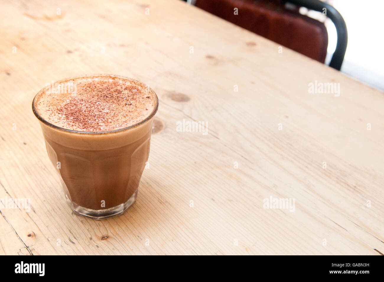 Cafe interior background with fresh coffee on the table in the coffee ...