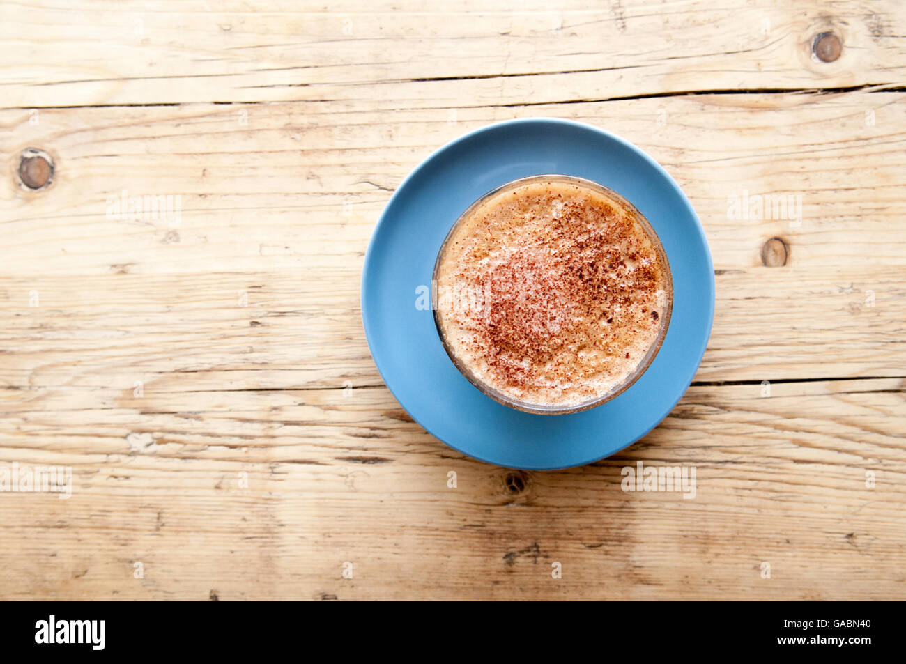 Cappuccino on a wooden cafe table viewed from above Stock Photo - Alamy
