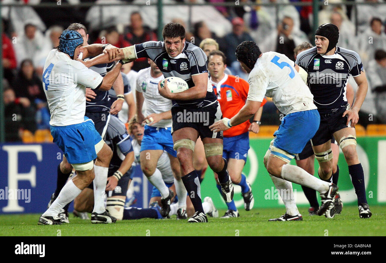 Scotland's Jim Hamilton hands off Italy's Santiago Dellape during the ...