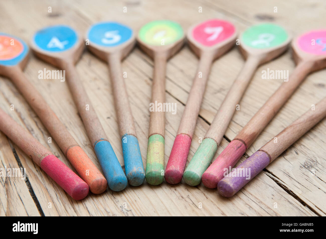 Brightly colored wooden spoons with numbers in a sequence arranged in a ...
