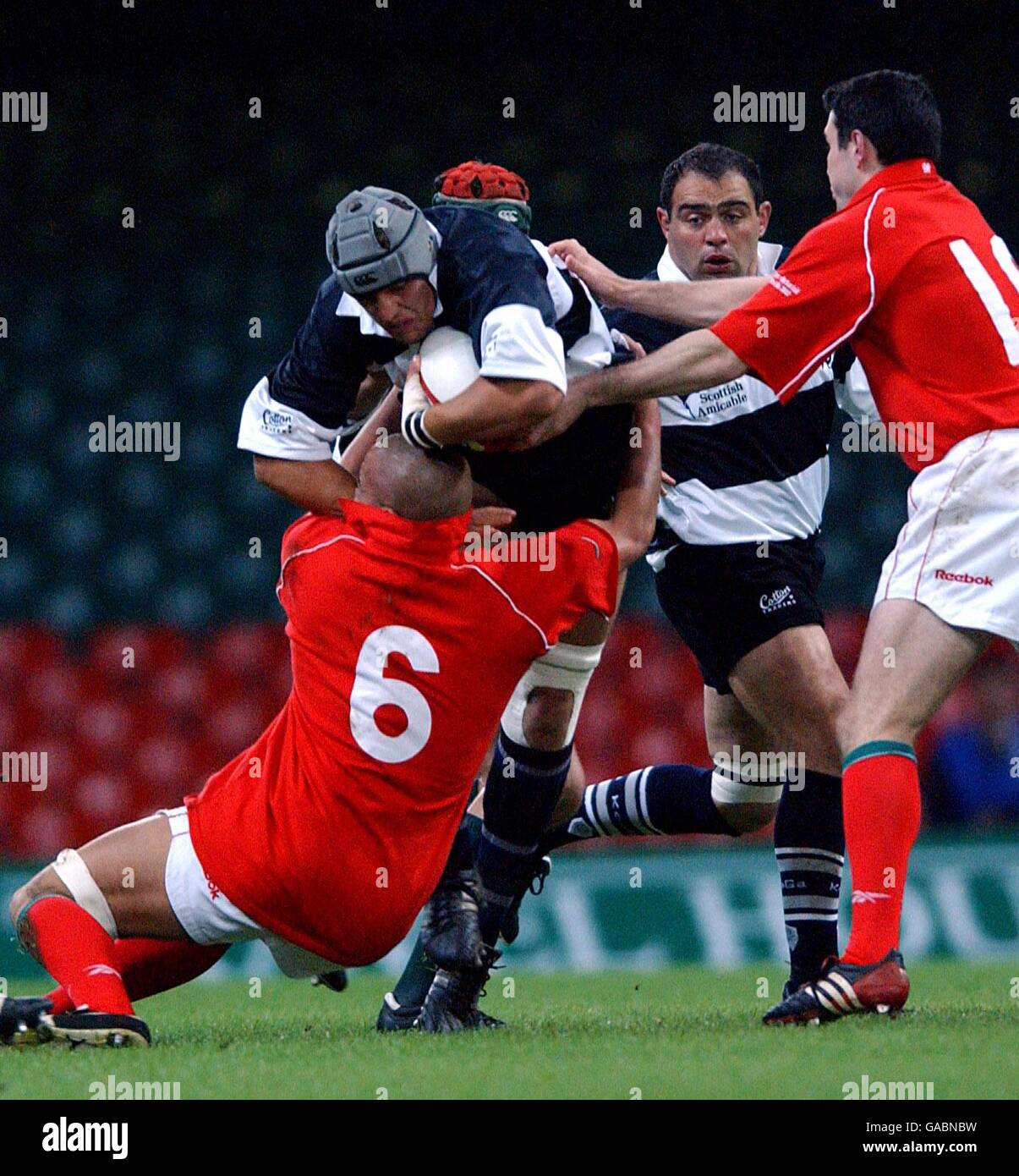 Barbarians' Kieran Roche is tackled by Wales' Gavin Thomas (l) and ...