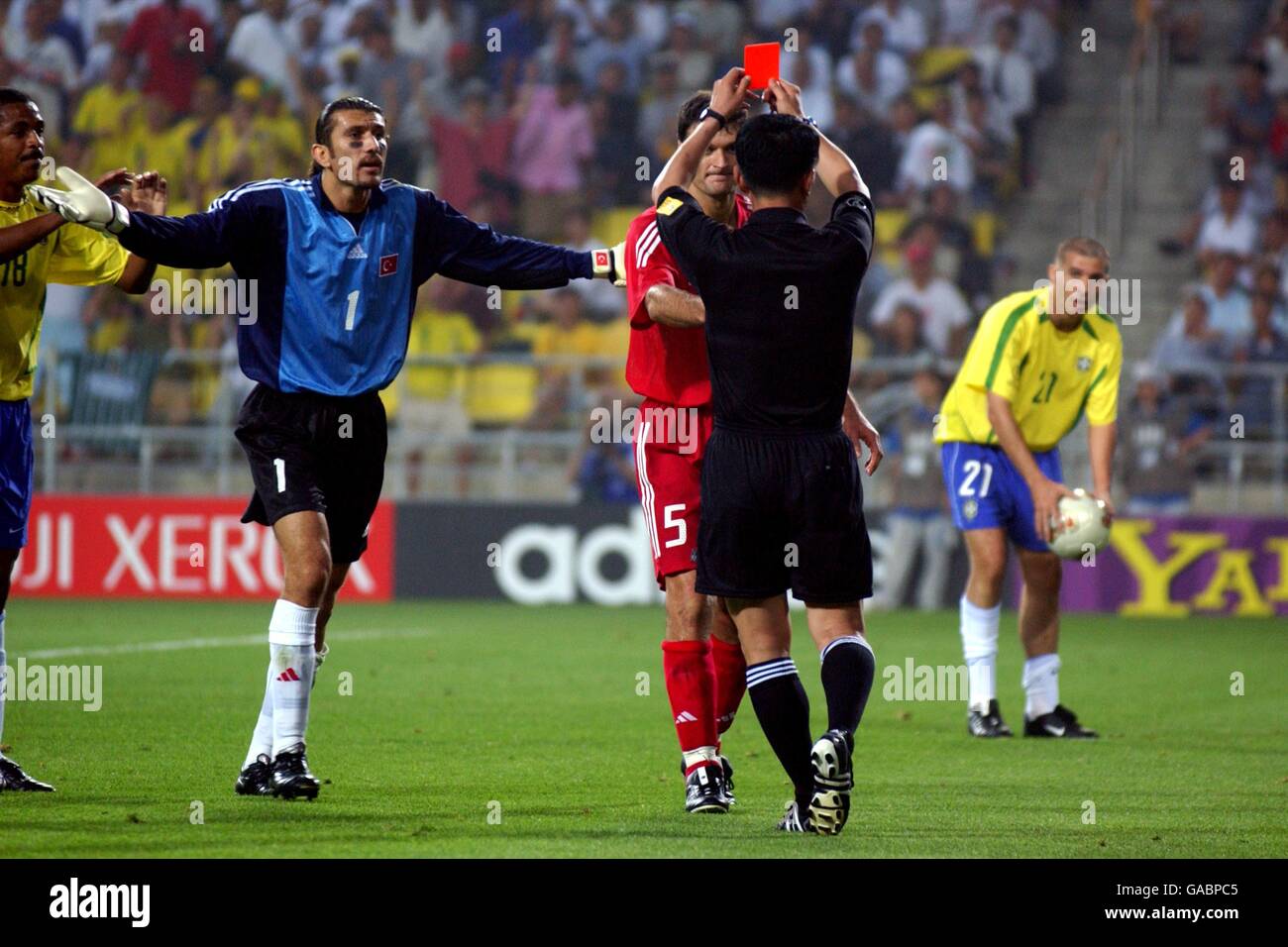 Referee Young Joo Kim shows the red card to Turkey's Alpay Ozalan Stock ...