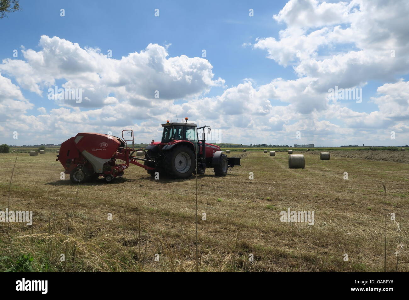 Agriculture tractors making hay bales hi-res stock photography and ...