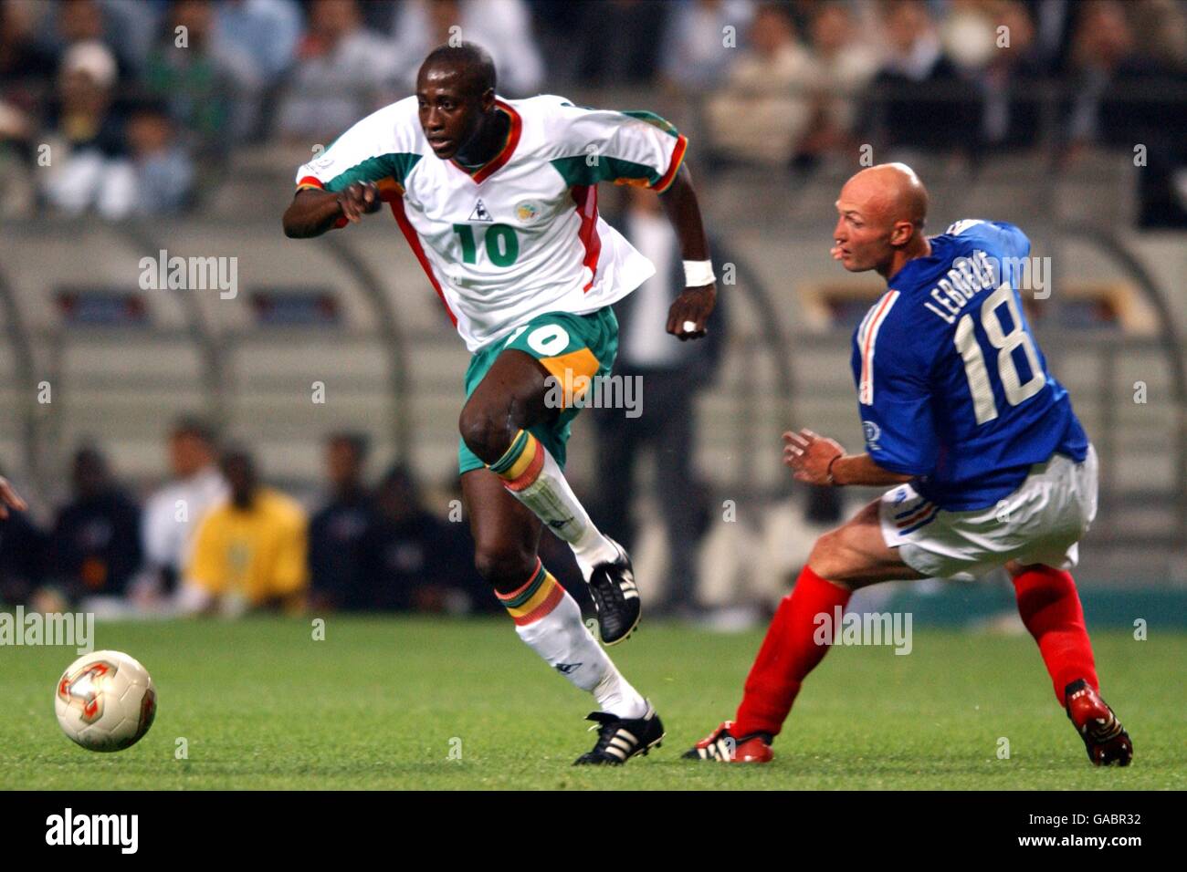 Senegal's Khalilou Fadiga (l) skips past France's Frank Leboeuf Stock ...