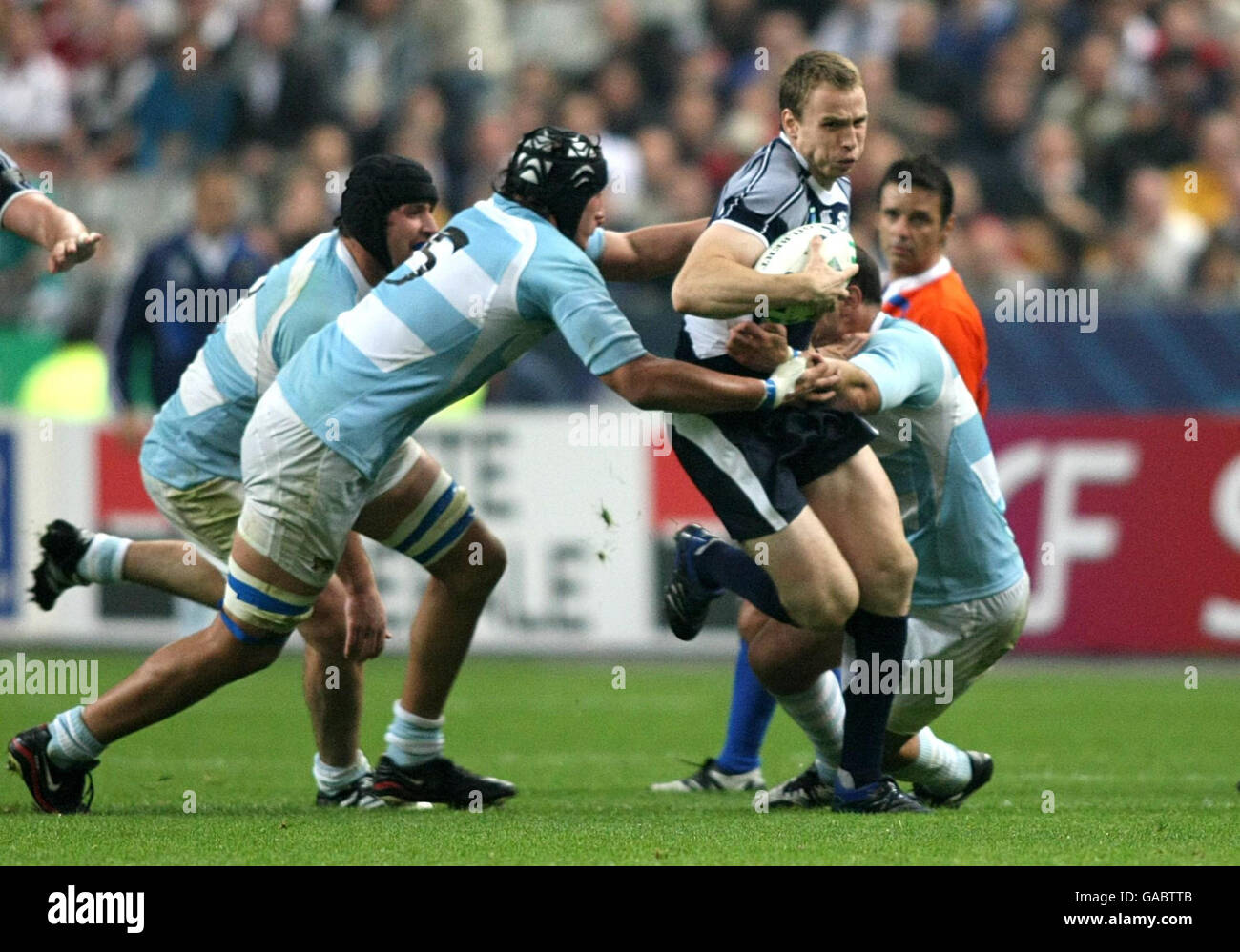 Scotland's Dan Parks is tackled by Argentina's Gonzalo Longo (r) and ...