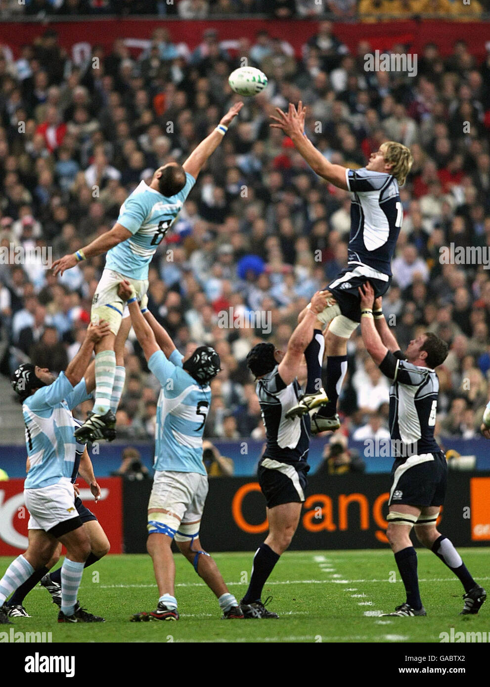 Argentina's Gonzalo Longo and Scotland's Sean Lamont jump at the line ...