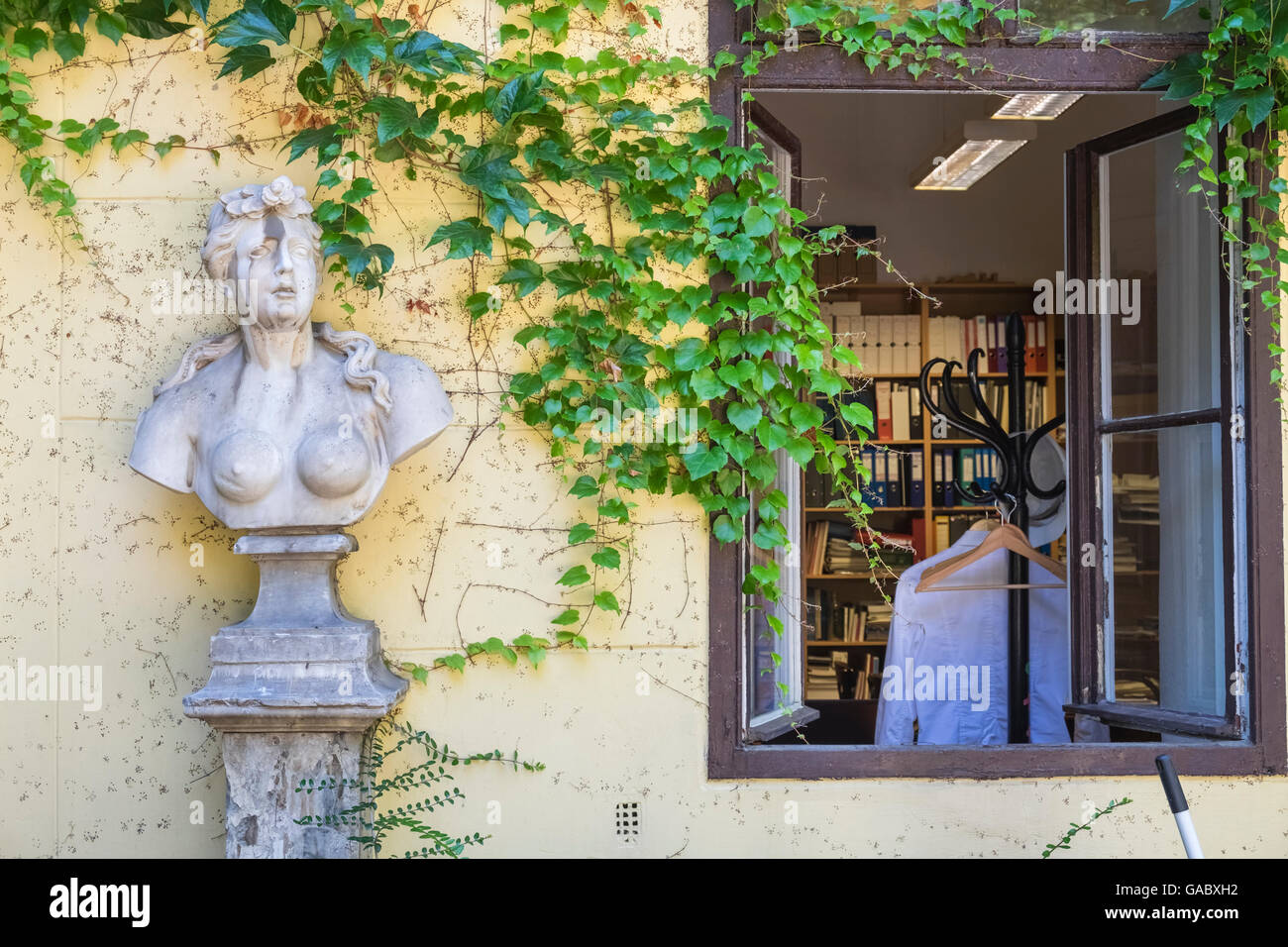 Outside looking through open window into office space Stock Photo - Alamy