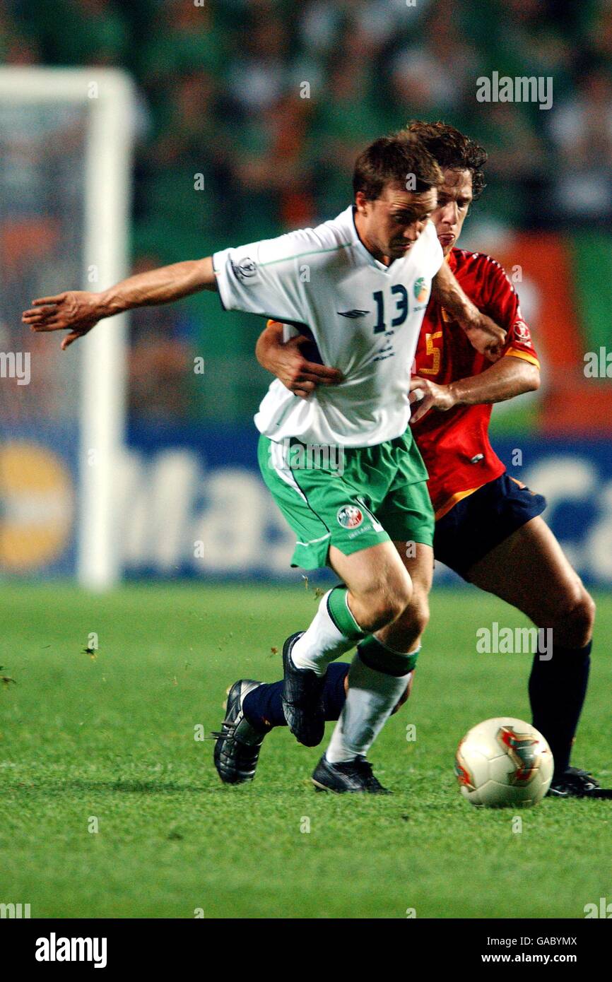 Ireland's David Connelly gets some close marking from Spain's Puyol ...