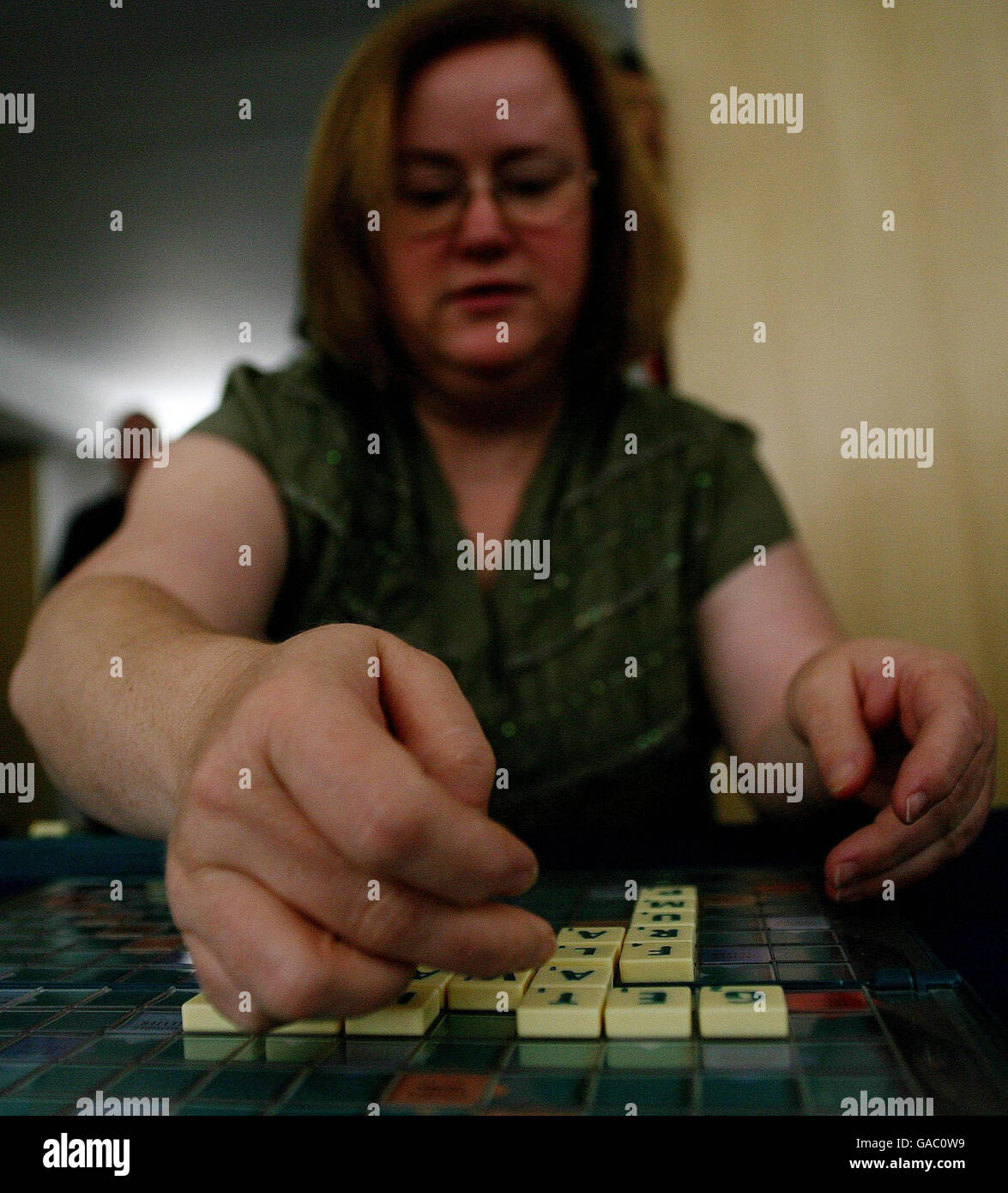A woman plays scrabble during the 36th National Scrabble Championships ...