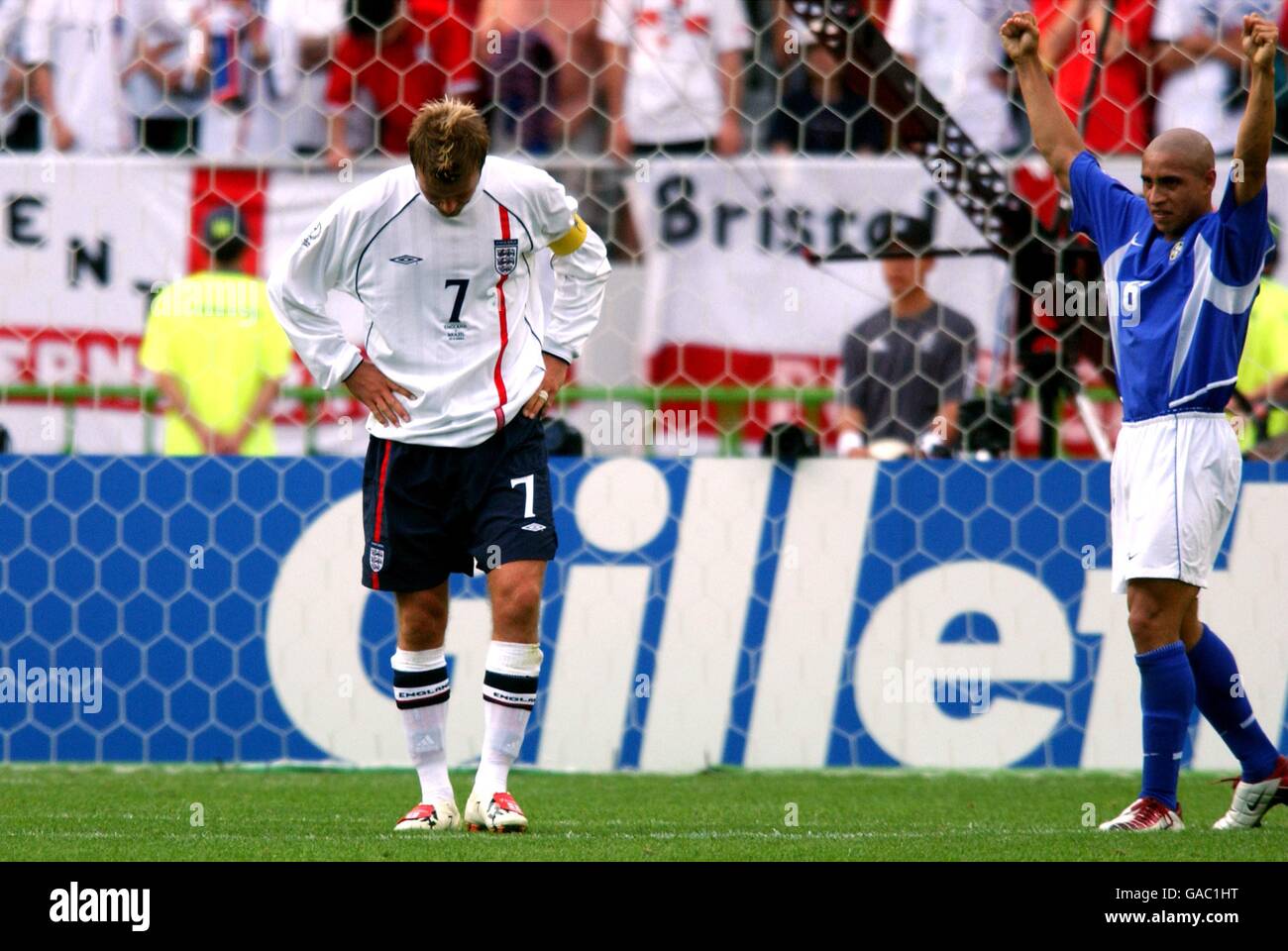 Dejected david beckham of england as brazils roberto carlos celebrates ...