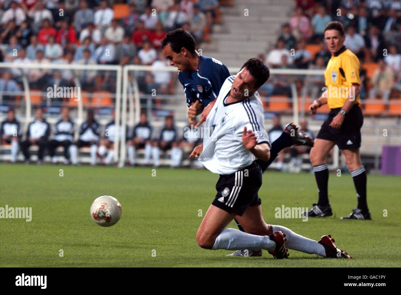 Germanys michael ballack is brought down by usas landon donovan hi-res ...