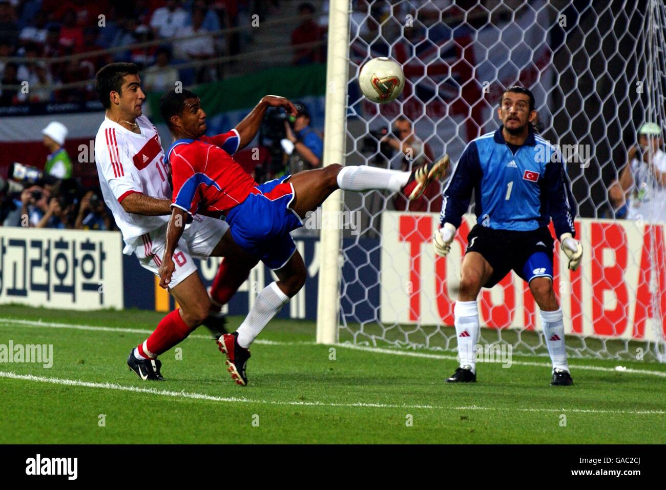 Costa Rica's Steven Bryce (c) tries to lift the ball over Turkey ...