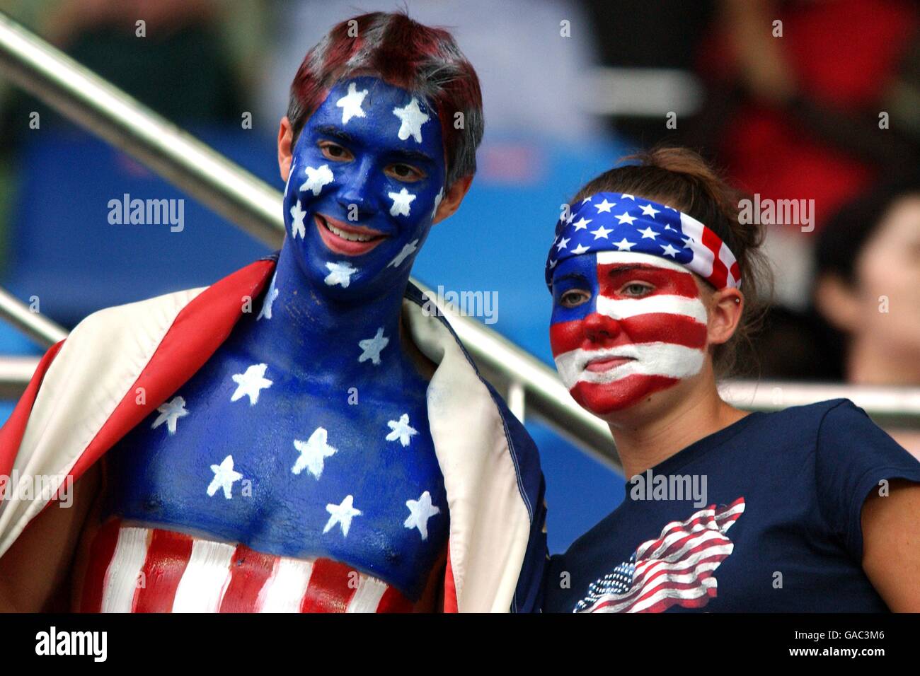 Two USA fans painted in the "Stars And Stripes" to support their team ...