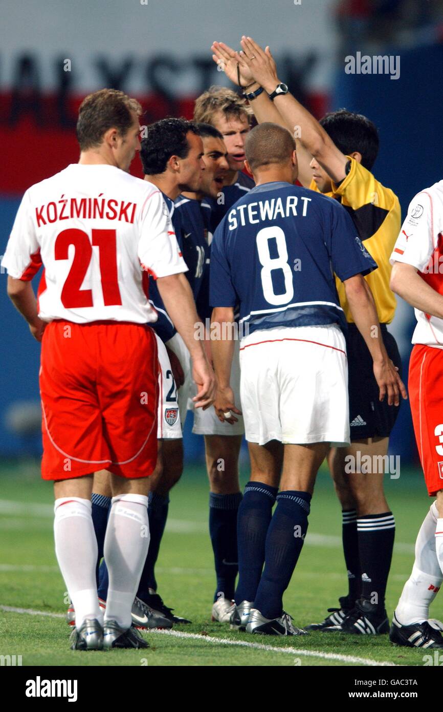 The Referee Jun Lu is surrounded by players from both sides after a ...
