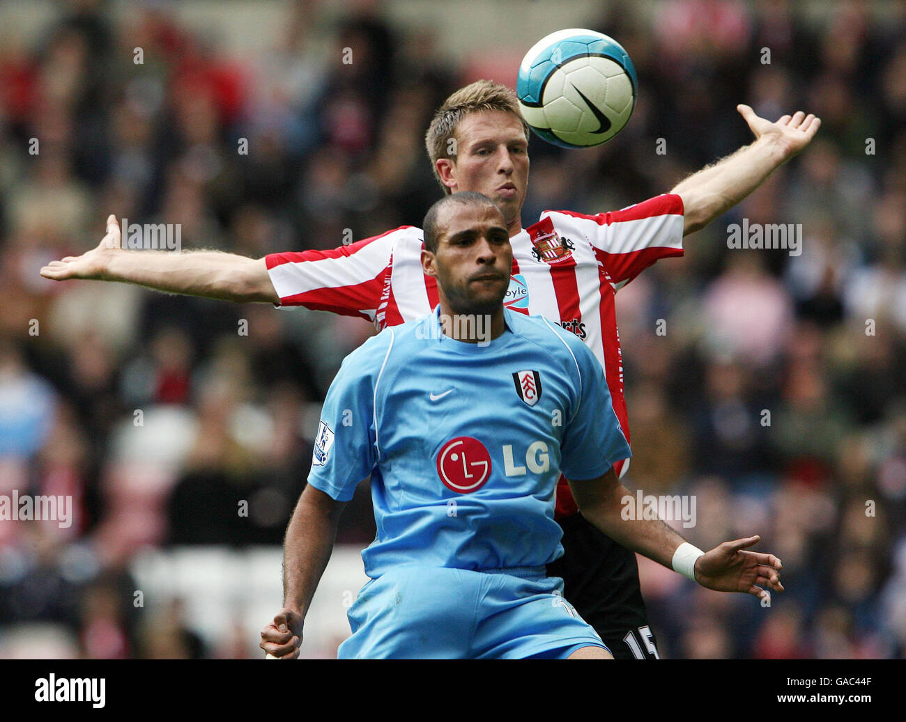 Sunderland's Danny Collins and Fulham's Diomansy Kamara battle for the ...