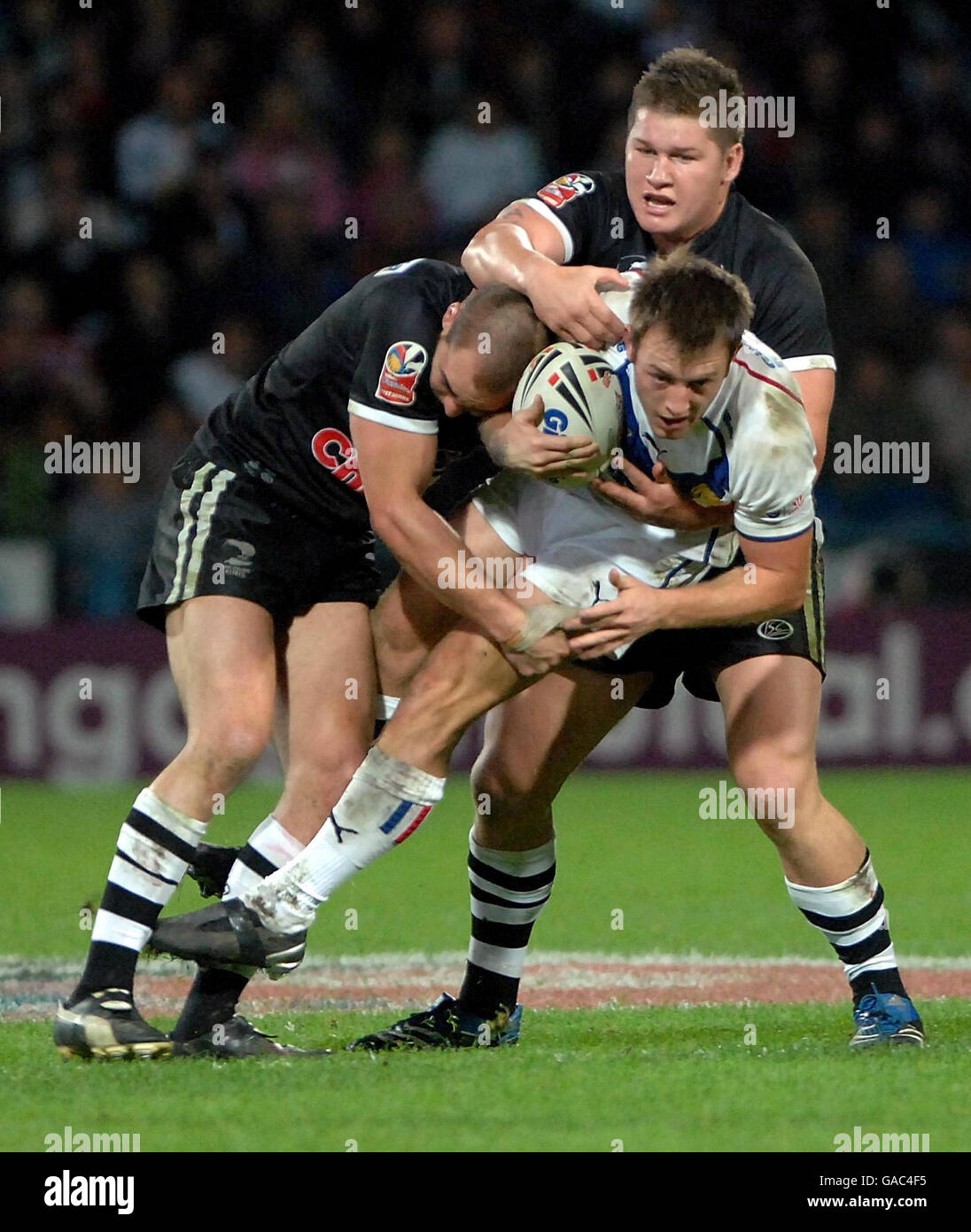 Greast Britain's James Roby is lifted from the ground by New Zealand's ...