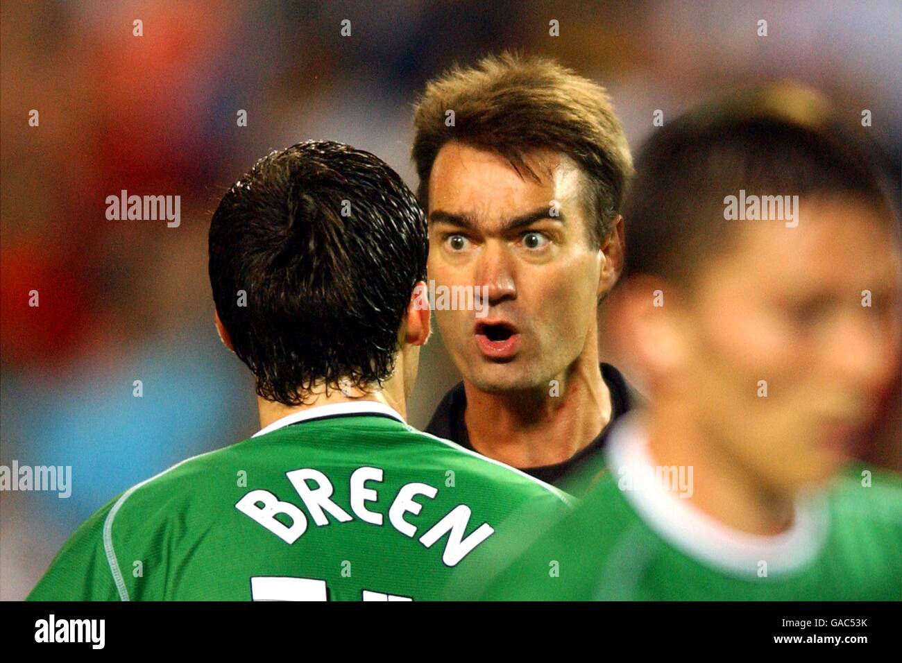 Referee Kim Milton Nielsen has a strong word with Ireland's Gary Breen ...