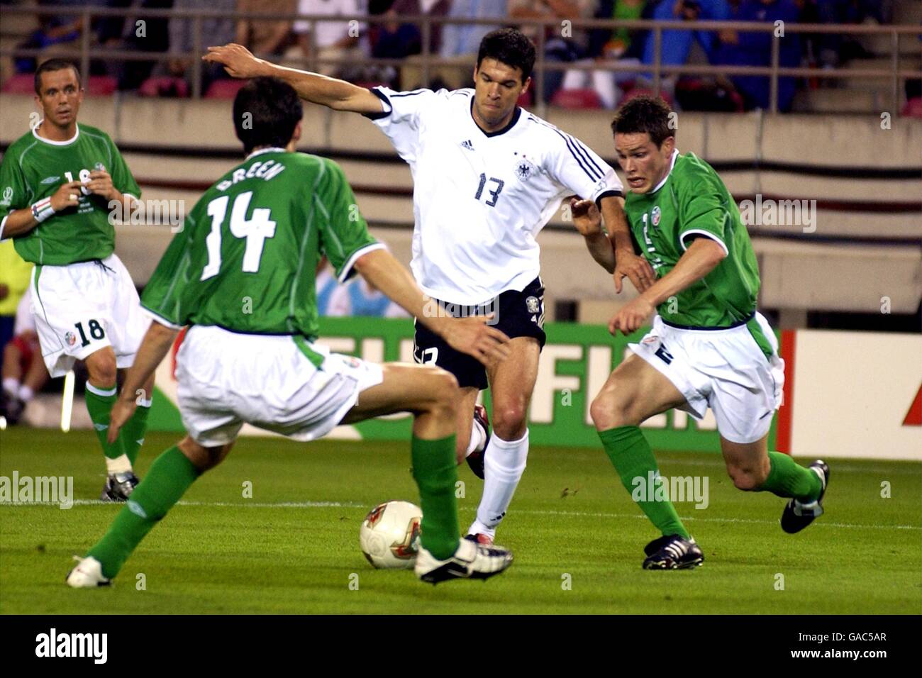 Germanys michael ballack takes on irelands gary breen steve finnan hi ...