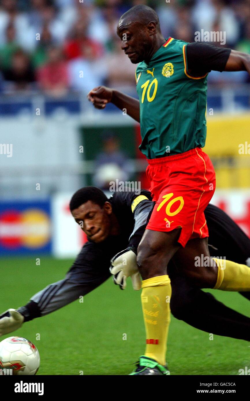 Saudi Arabia goalkeeper Mohammed Al Deayea saves at the feet of ...