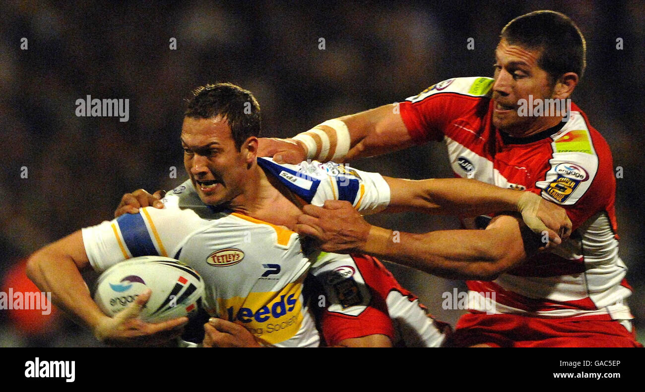 Leeds Rhinos Danny McGuire is tackled by Wigan's Bryan Fletcher during ...