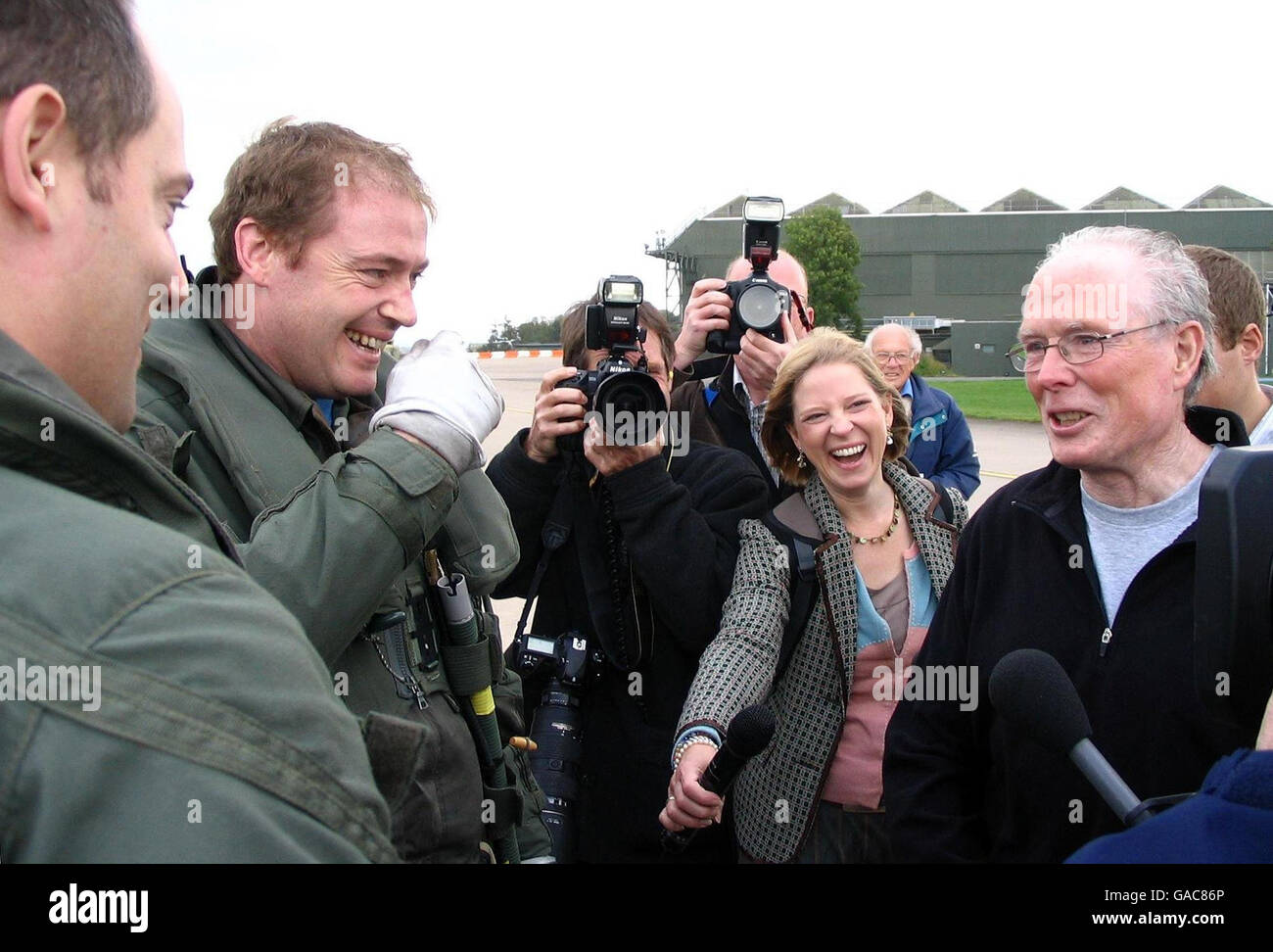 John Russell, 65, (right) meets Flight Lieutenant Mark Haley (left) and ...