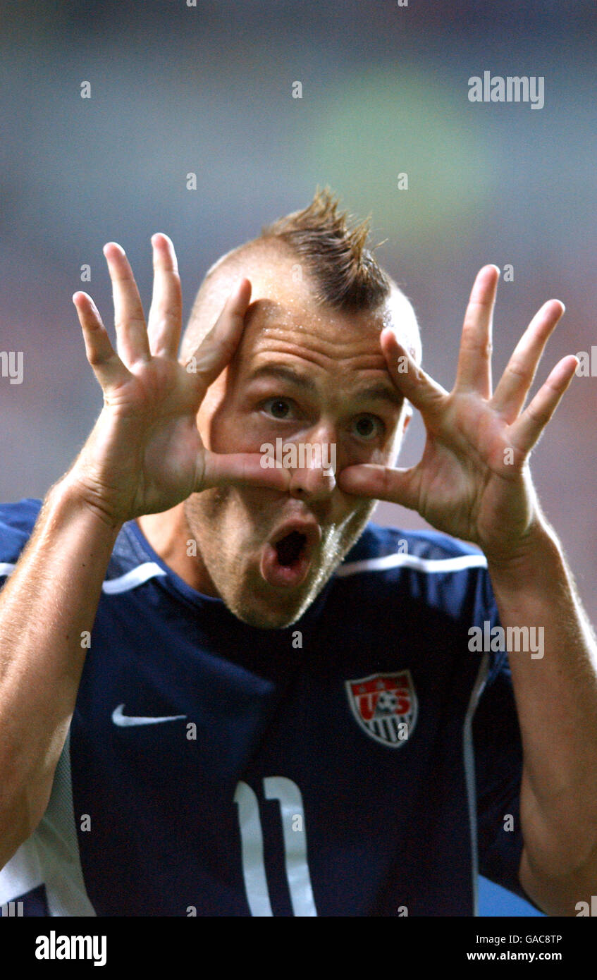 USA's Clint Mathis indicates the linesman needs his eye sight checked ...