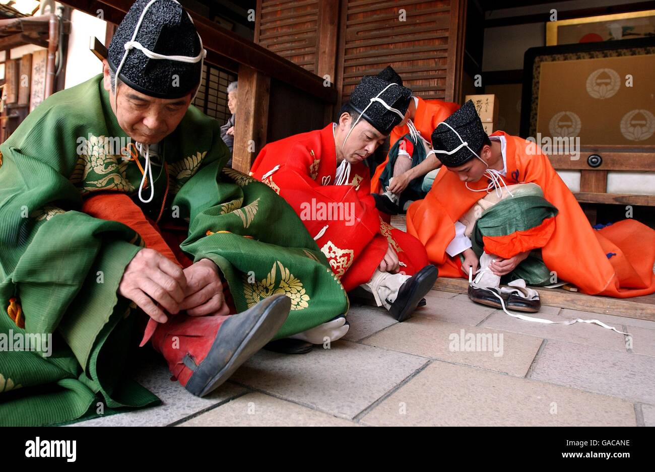 Kemari players tie their laces at the famous fujinomori shrine hi-res ...