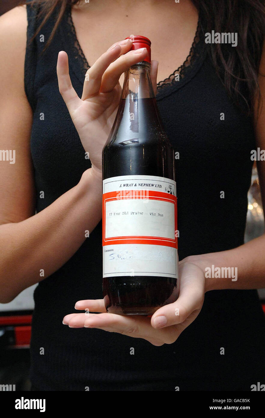 Model Imogen Allen holds one of the most expensive bottles of rum ...