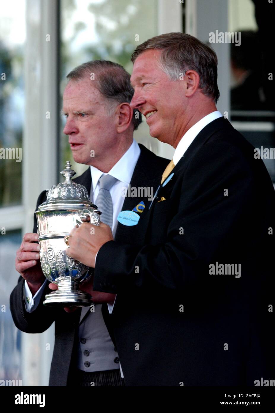 Sir Alex Ferguson (r) celebrates with the trophy for winning owner ...