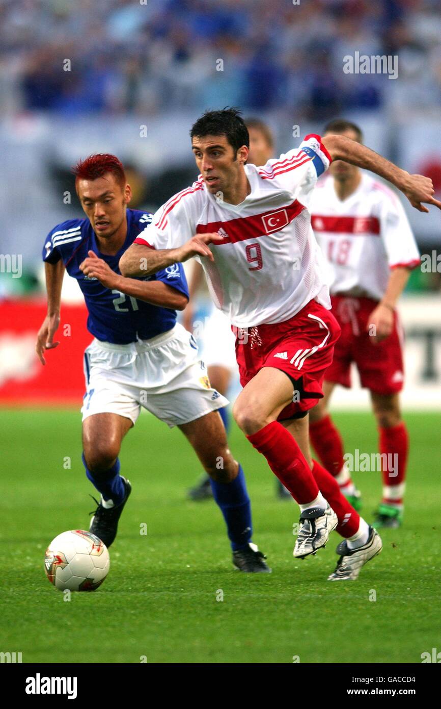 Turkeys hakan sukur r goes past japans kazuyuki toda hi-res stock ...