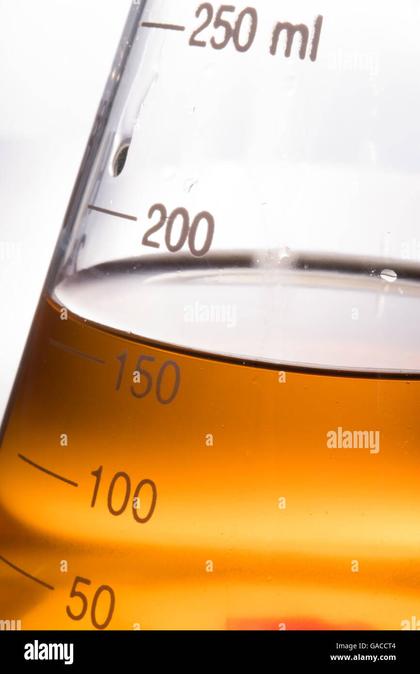 Orange chemical reaction in flask Stock Photo - Alamy