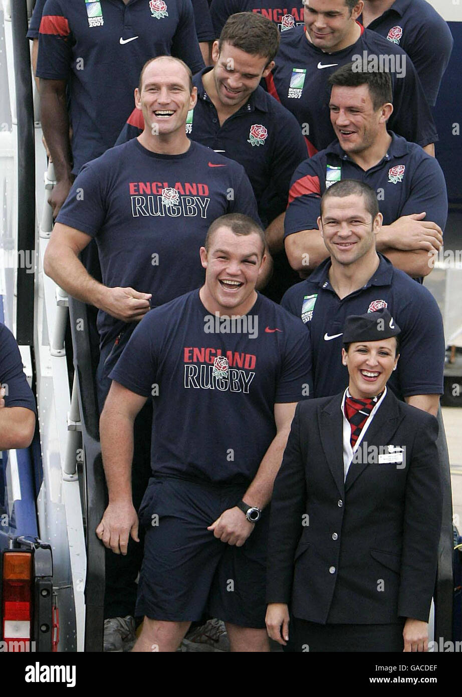 Members of England's rugby union team line up on the steps of their ...