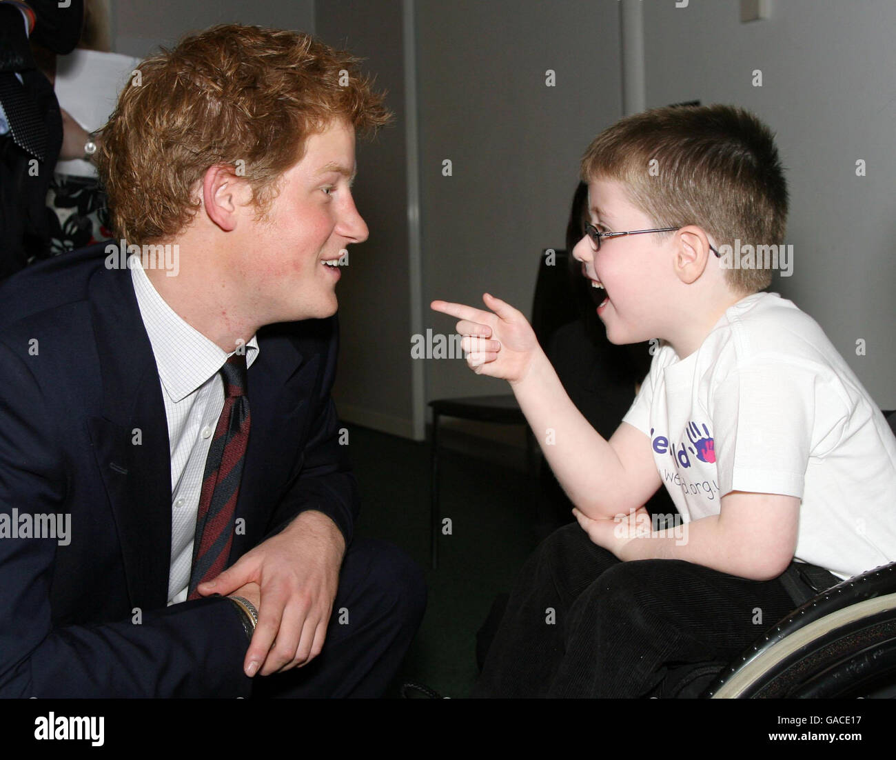 Britain's Prince Harry, left, talks with Christopher Anderson, right ...