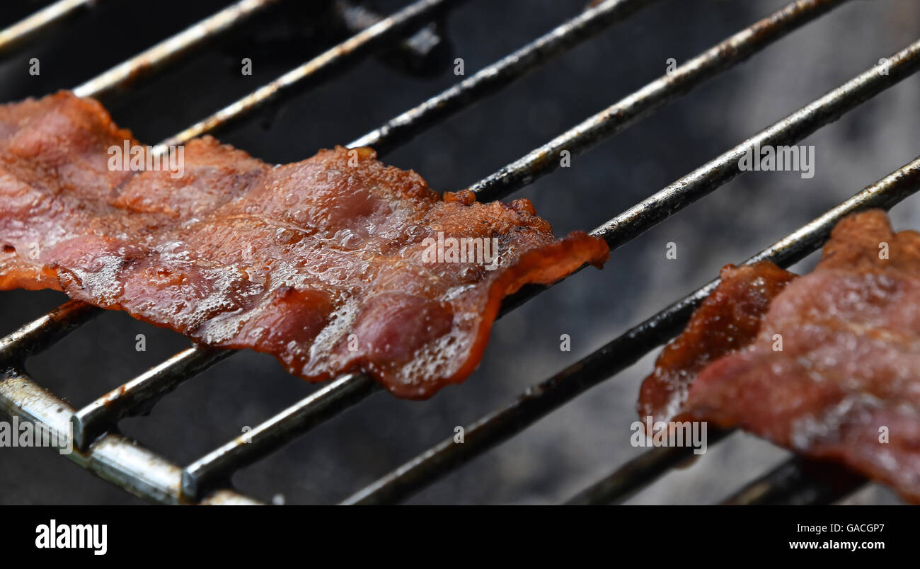 One crispy smoked grilled barbecue bacon slice, cooked on bbq smoke ...