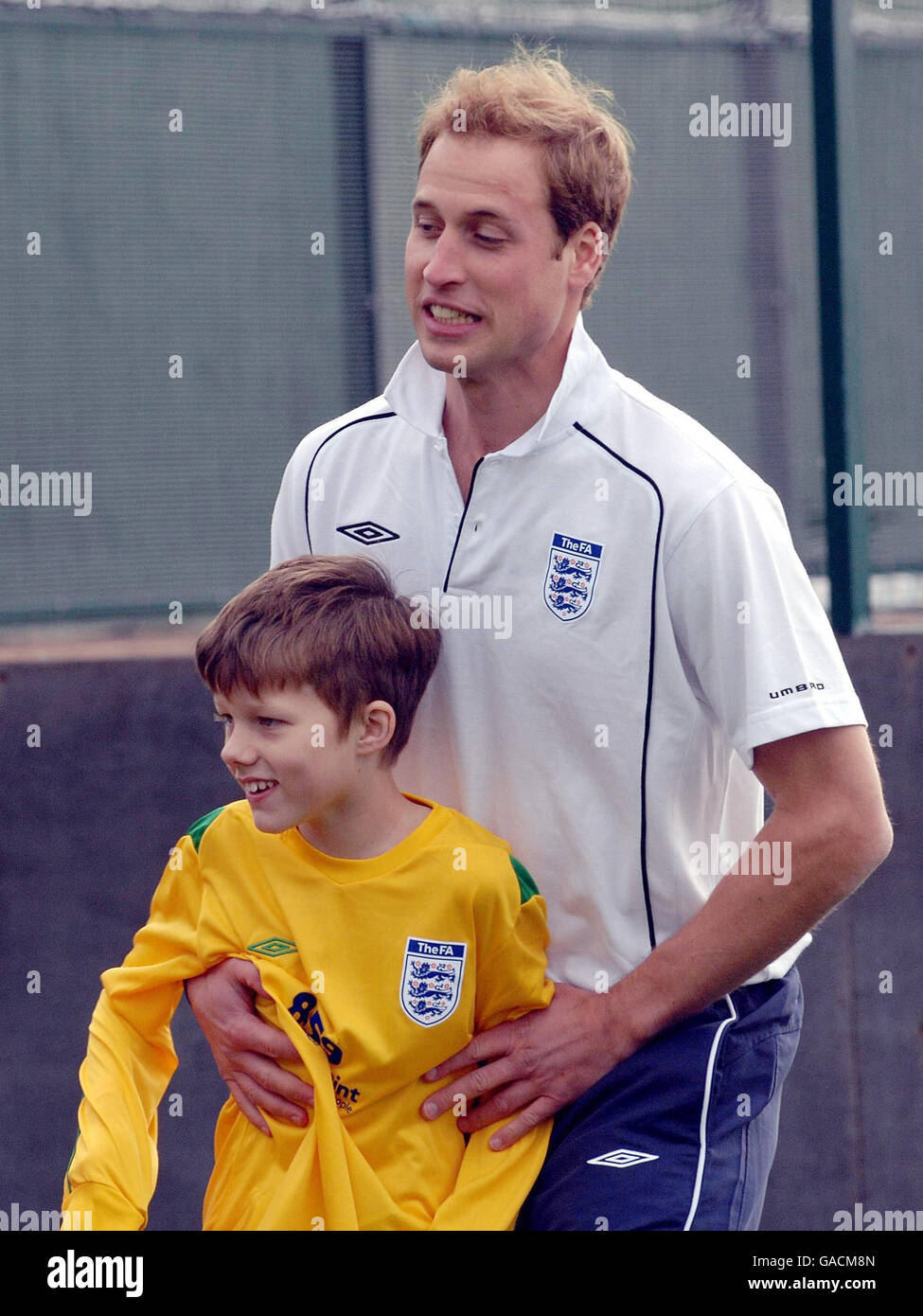 Prince William plays football alongside youngsters during a visit to ...