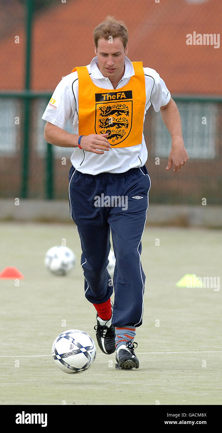 Prince William plays football alongside youngsters during a visit to ...