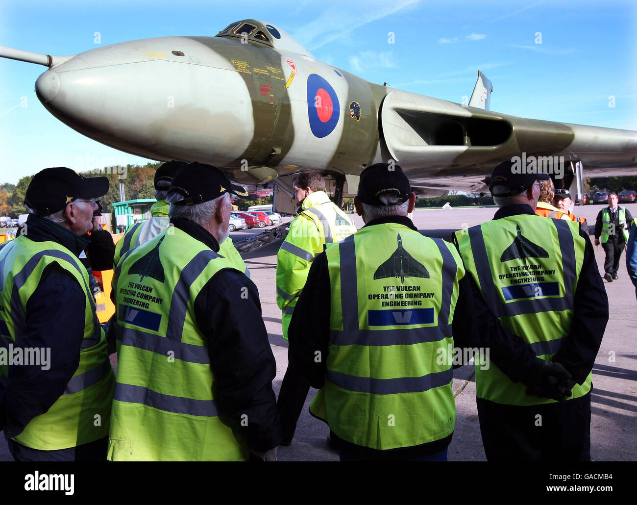 Volunteers watch as a Vulcan XH558 is rolled out of the hanger. The ...