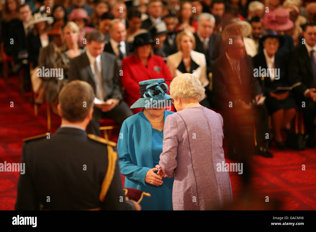 Is made an mbe by the queen at buckingham palace hi-res stock ...