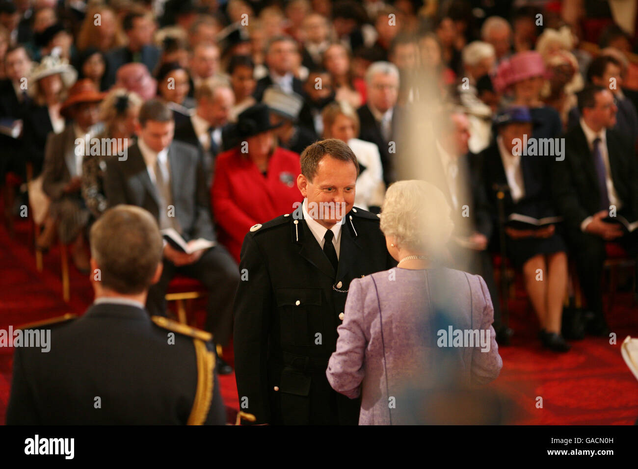 Mr. Ian Dickinson receives The Queen's Police Medal from The Queen at ...
