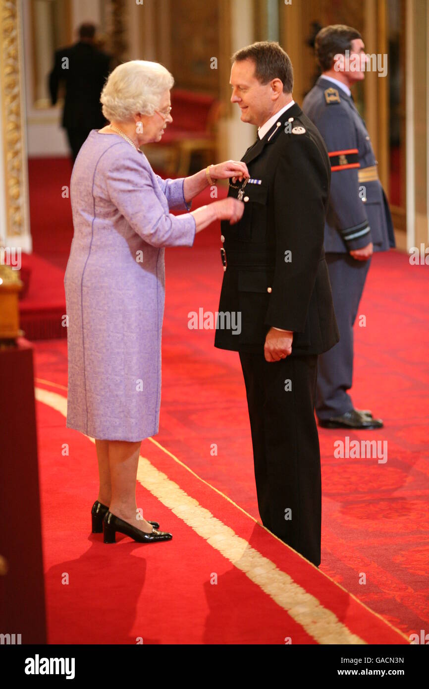 Mr. Ian Dickinson receives The Queen's Police Medal from The Queen at ...