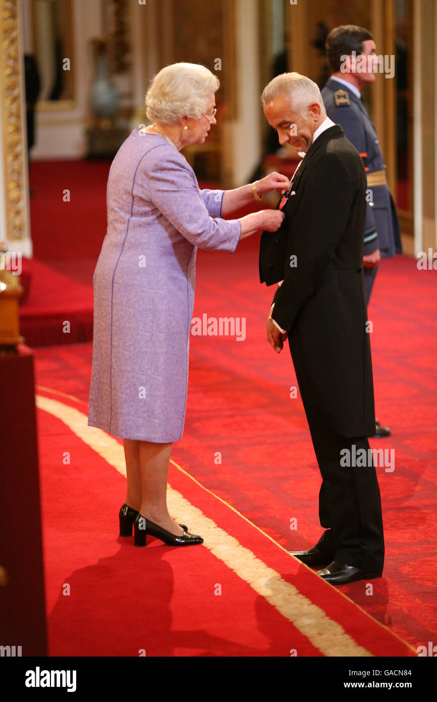 Mr. Graham Moore, from Cambridge, is made an MBE by The Queen at ...