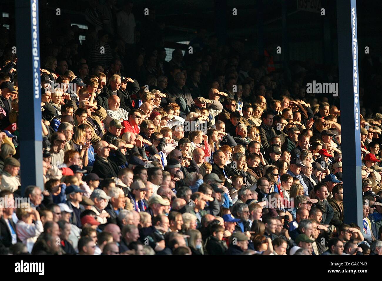 General view of the crowd sheltering their eyes from the sun in the ...