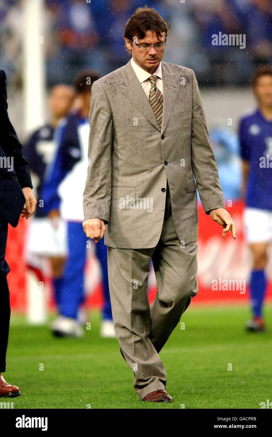 A dejected Japan coach Philippe Troussier trudges off after the defeat ...