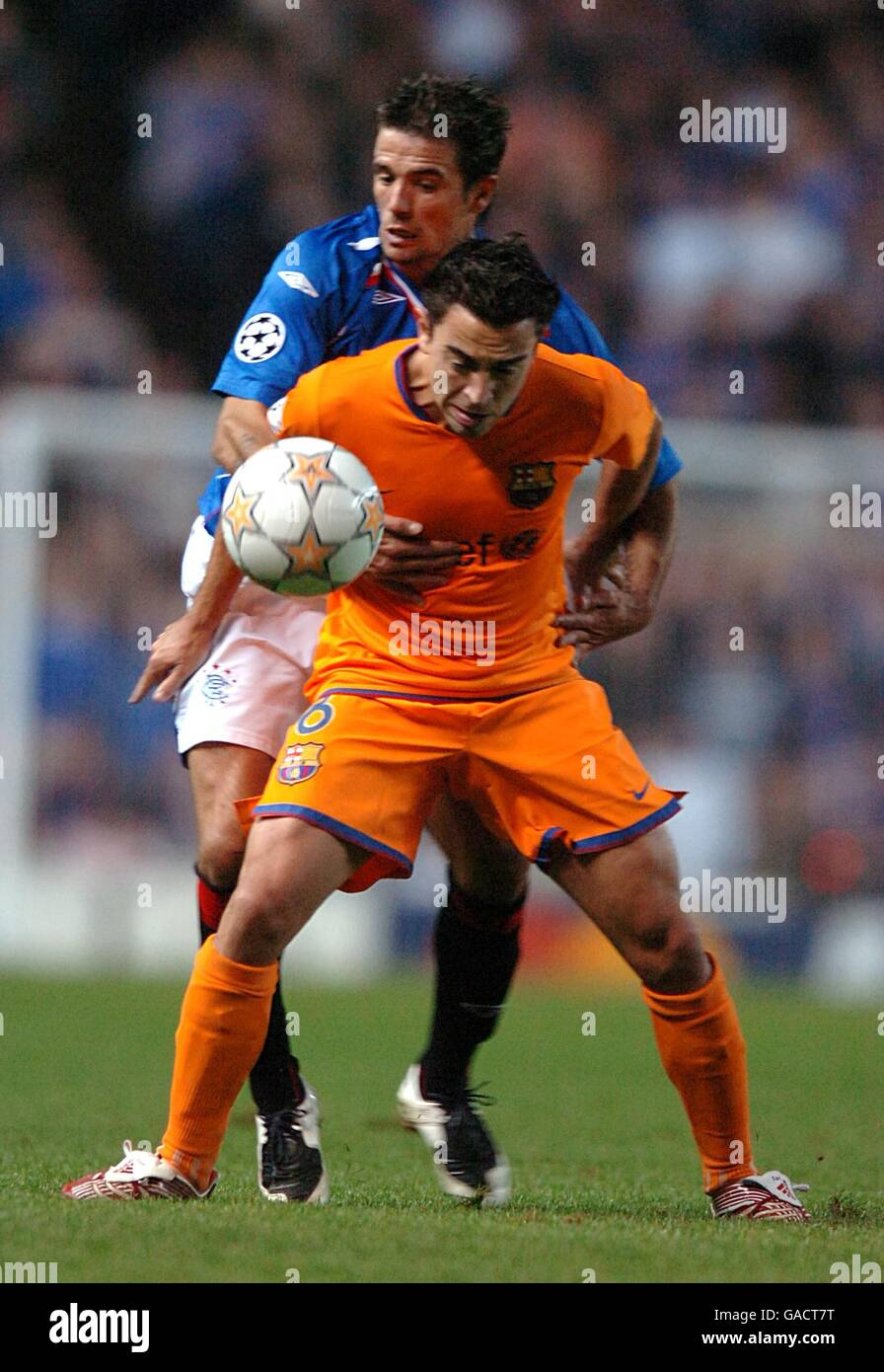 Barcelona's Xavi and Rangers' Nacho Novo battle for the ball Stock ...
