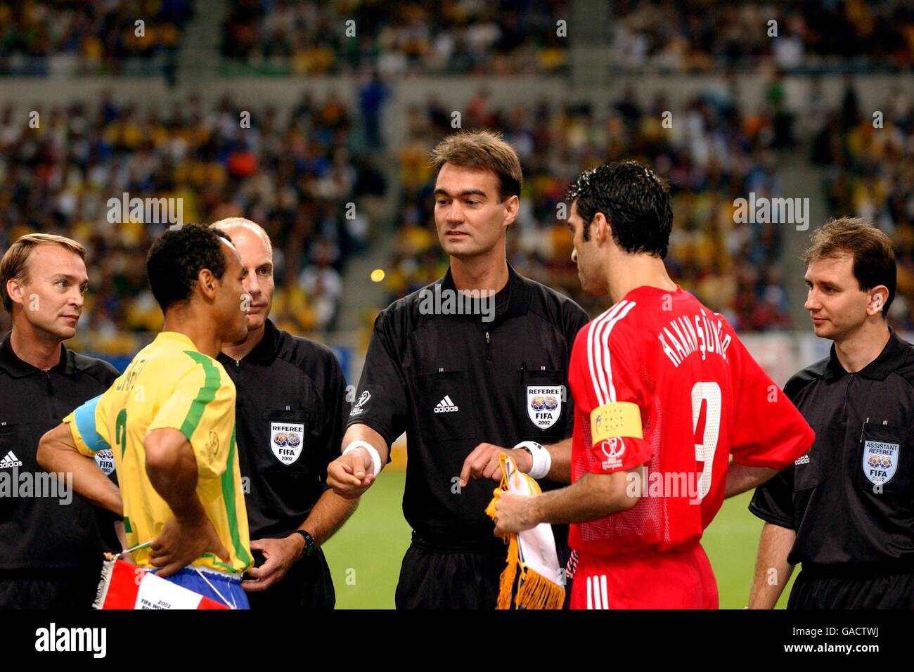 Referee Kim Milton Nielsen of Denmark tosses the coin with captains ...