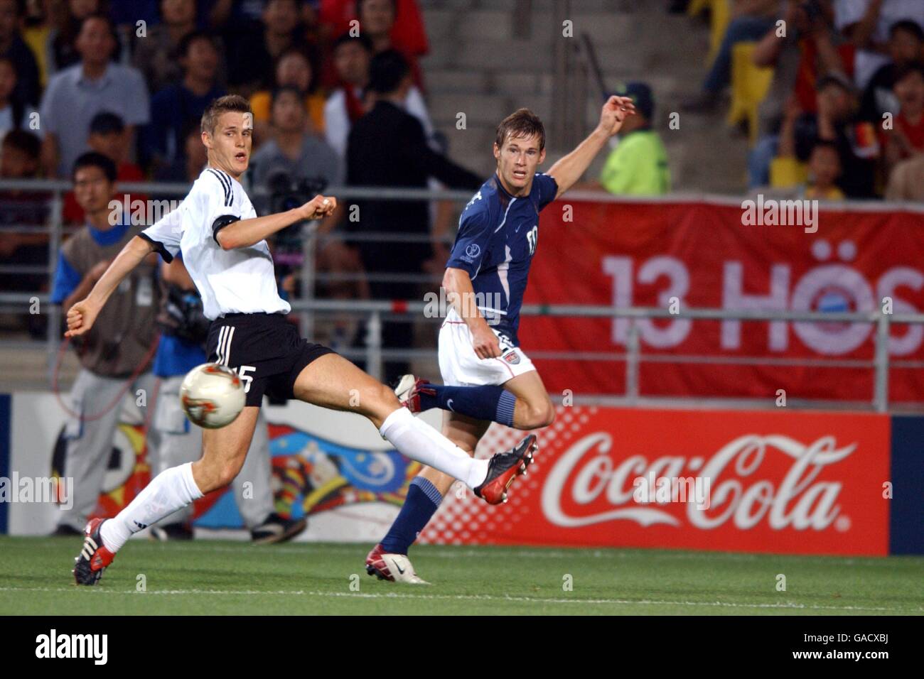 (L-R) Germany's Sebastian Kehl and USA's Brian McBride battle for the ...