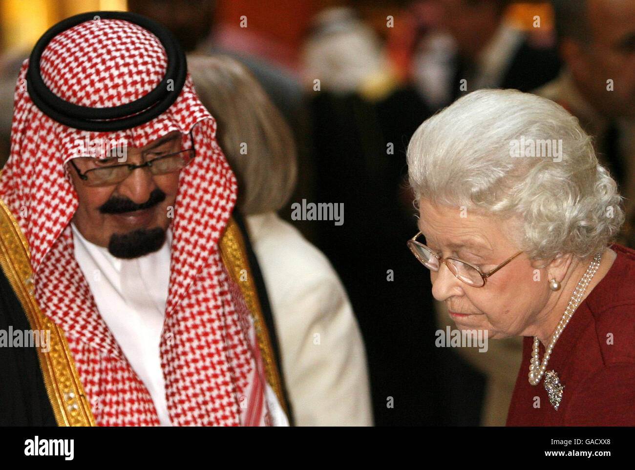 Britain's Queen Elizabeth II shows King Abdullah of Saudi Arabia items ...